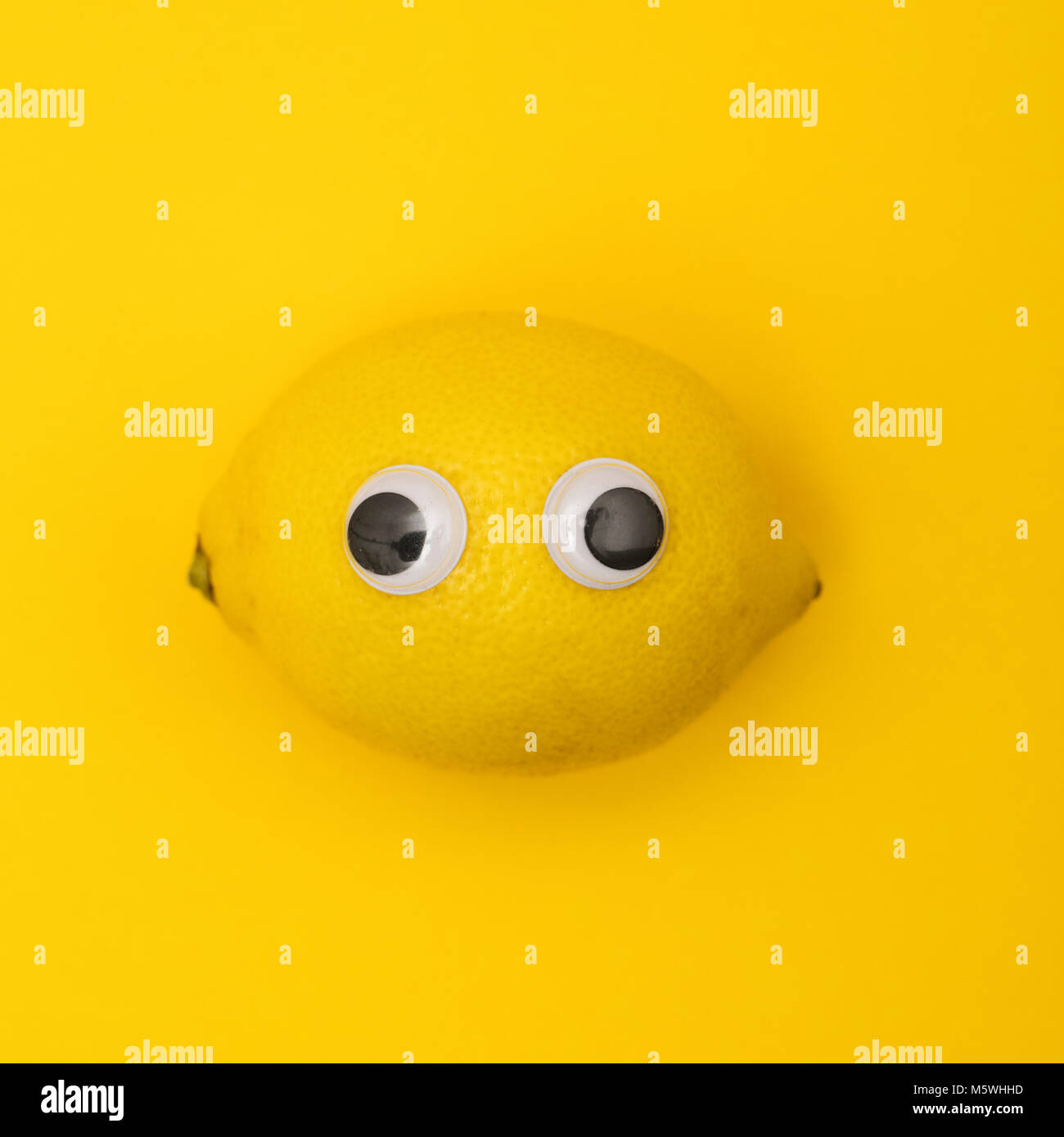 Yellow lemon face with comedy googly eyes Stock Photo - Alamy