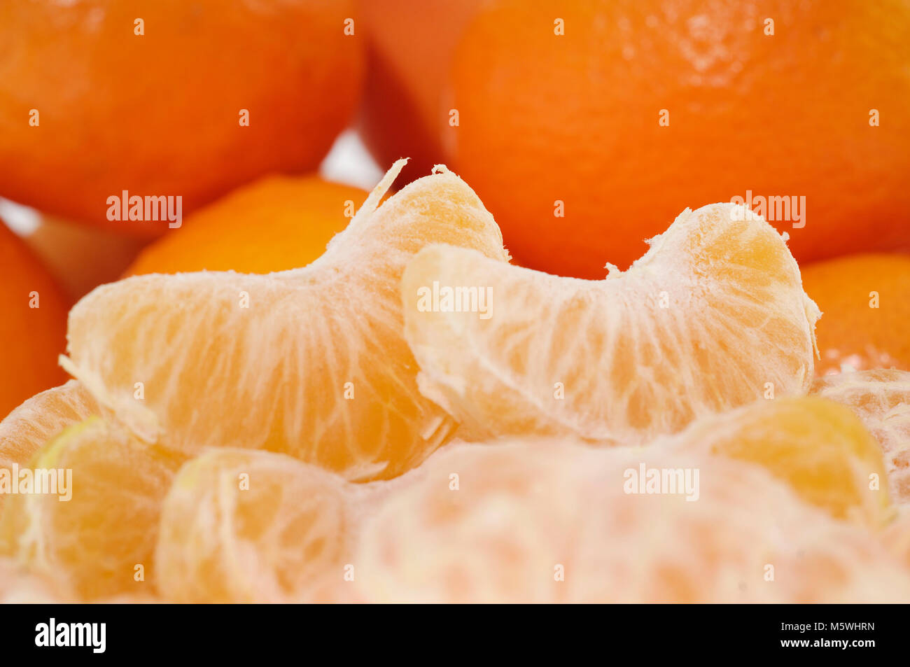 Whole orange fruits and peeled segments Stock Photo - Alamy