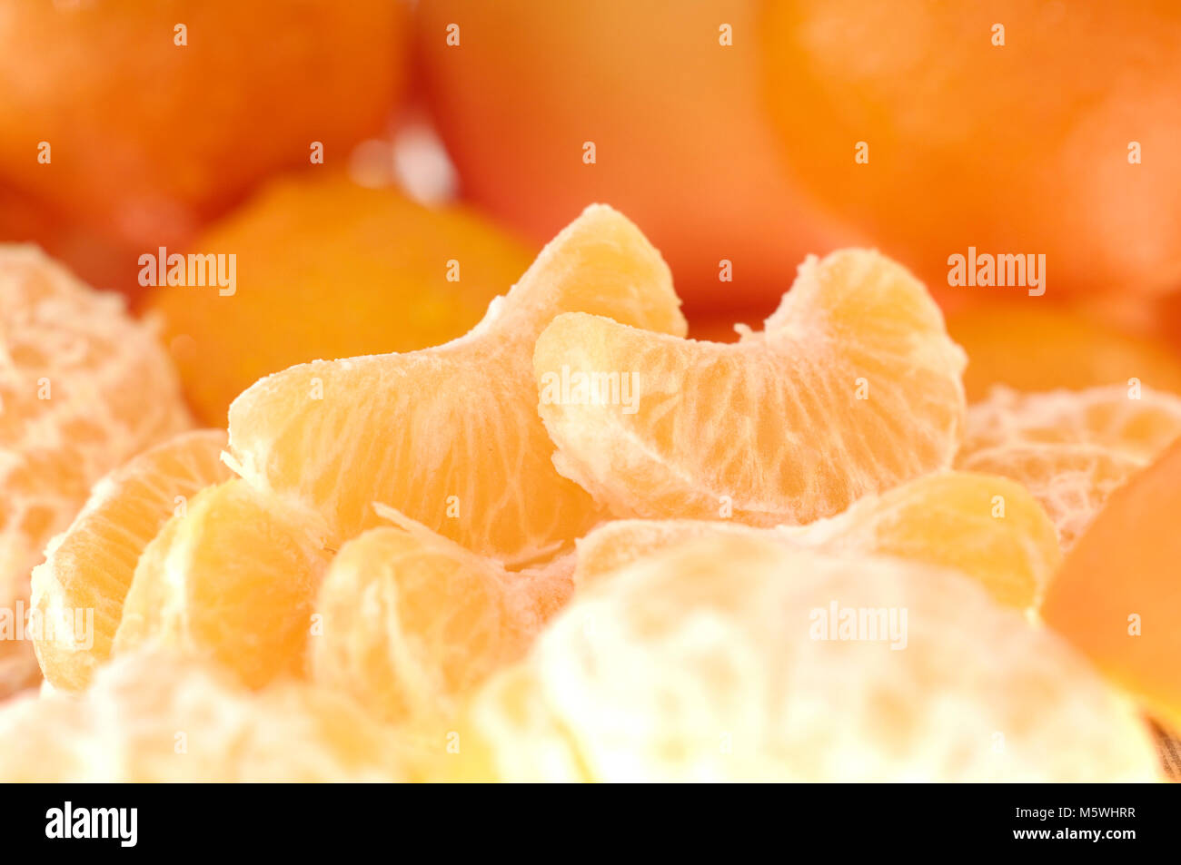 Whole orange fruits and peeled segments Stock Photo - Alamy