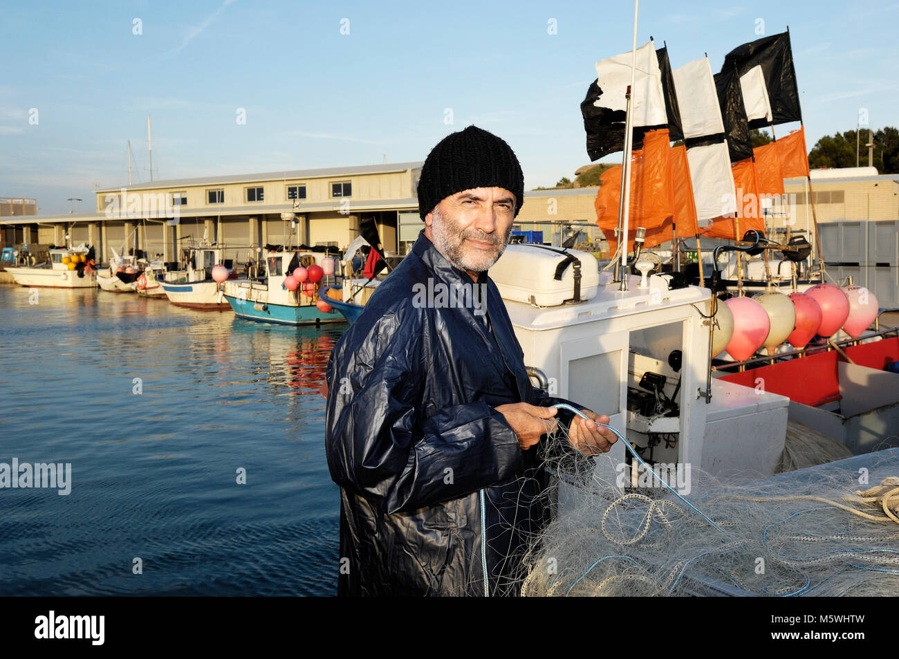fisherman working in the fishing port Stock Photo - Alamy