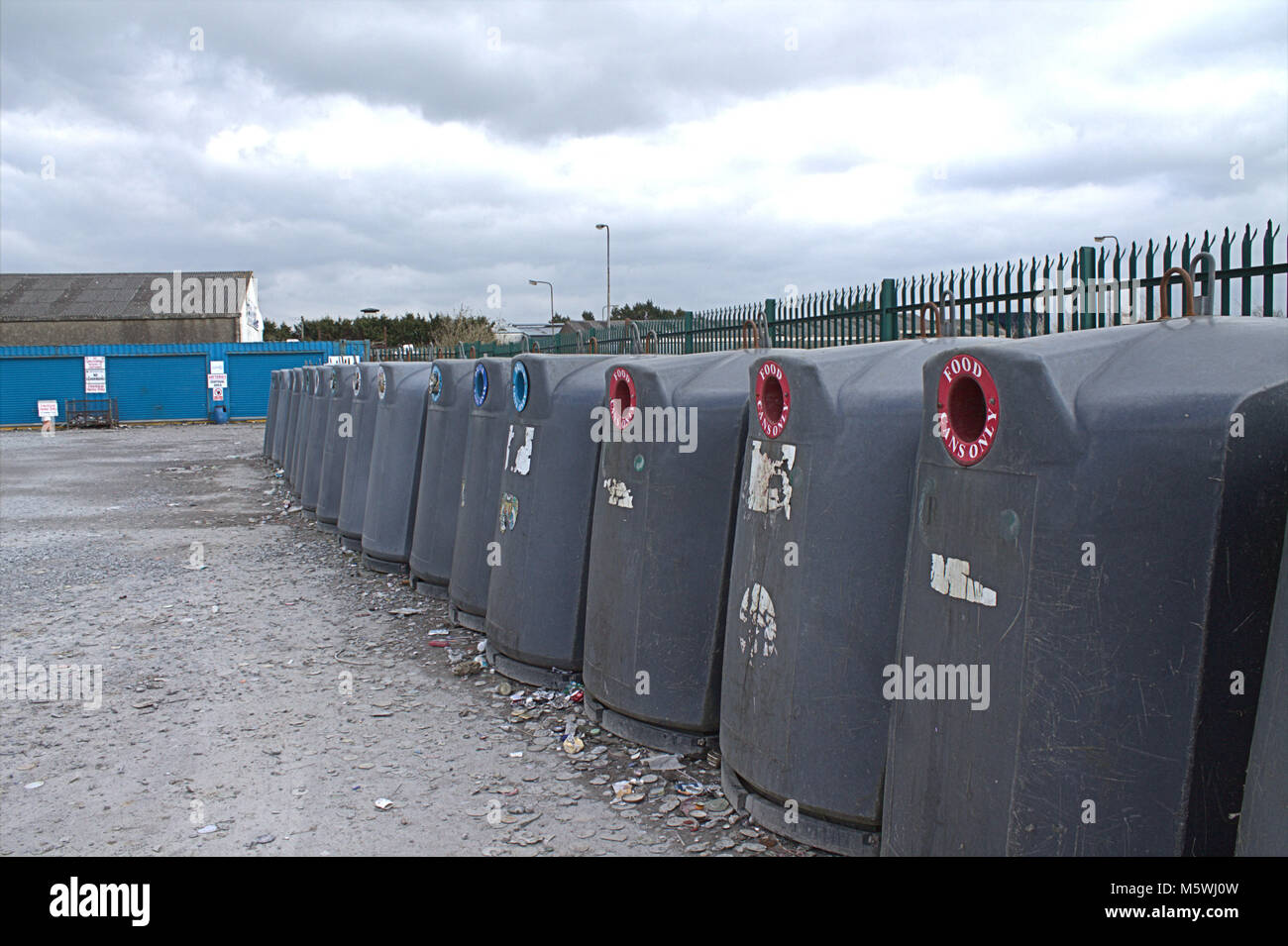 Line of recycling bins in a garbage dump Stock Photo - Alamy