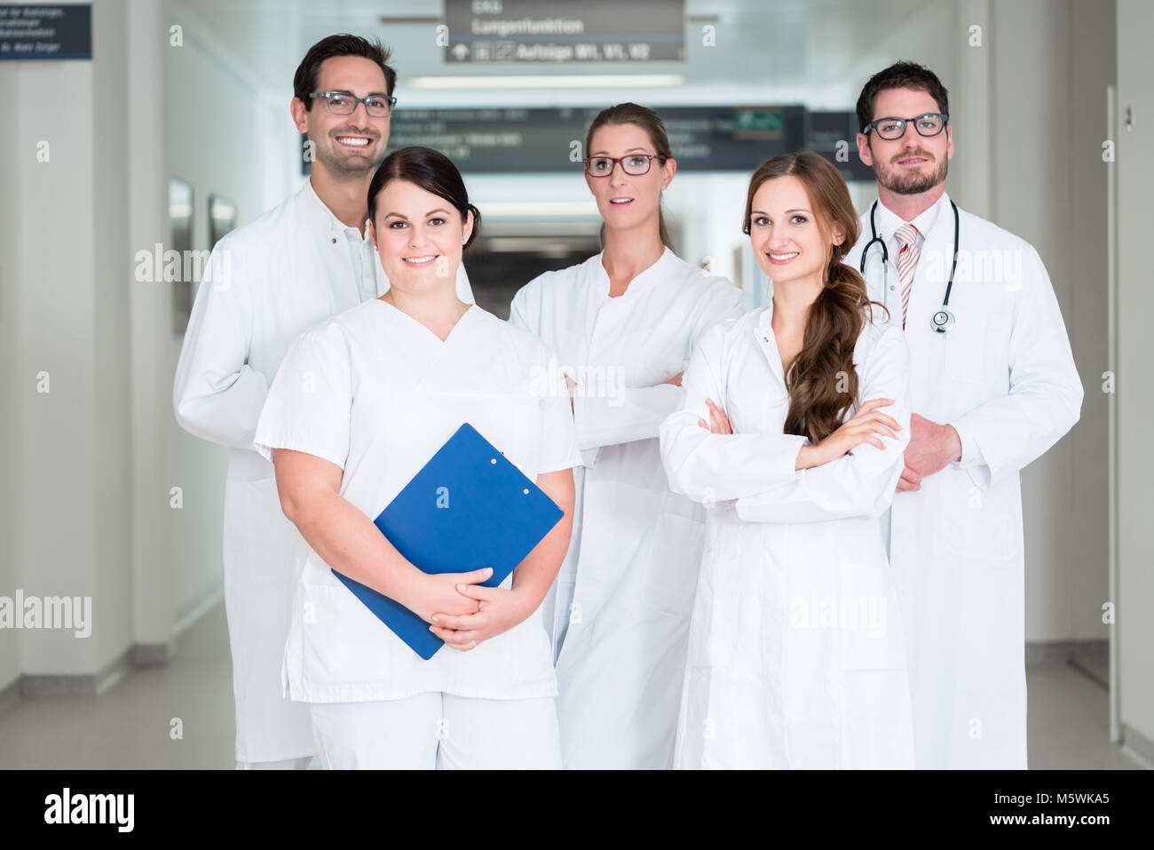 Team of doctors standing in hospital corridor Stock Photo - Alamy