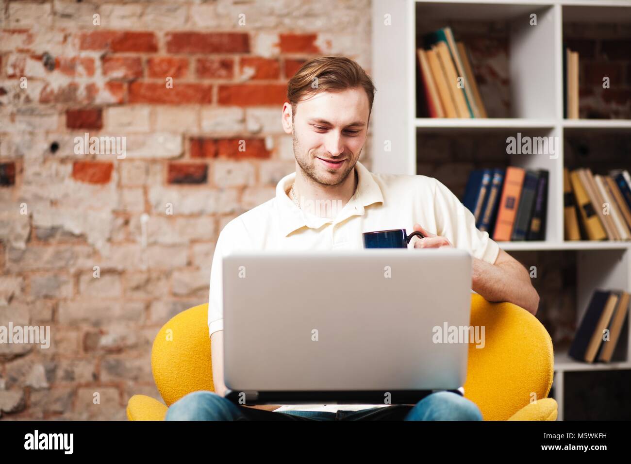 Young man with a laptop Stock Photo - Alamy