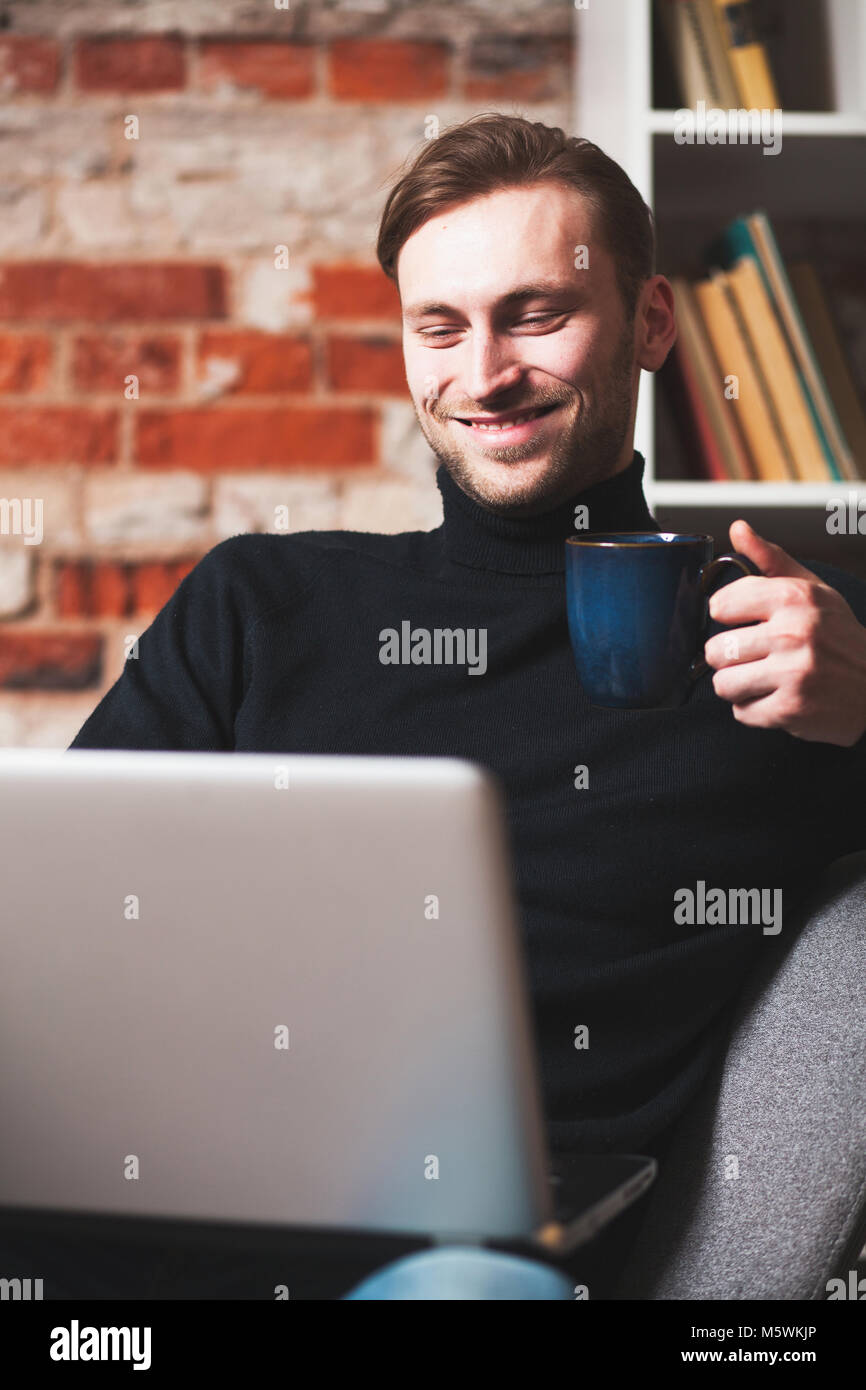 Young man with a laptop Stock Photo - Alamy