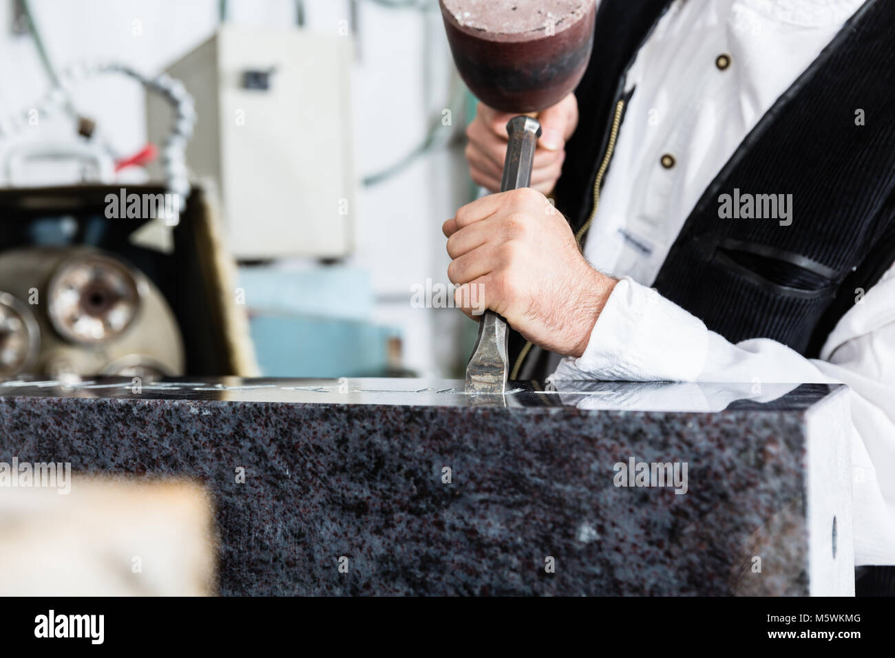 Stone mason working on tombstone in workshop Stock Photo - Alamy