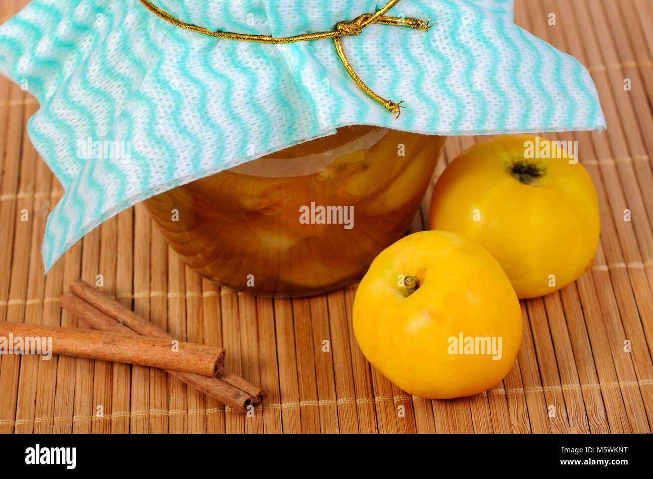 Glass jar with apple jam, yellow apples and cinnamon Stock Photo - Alamy