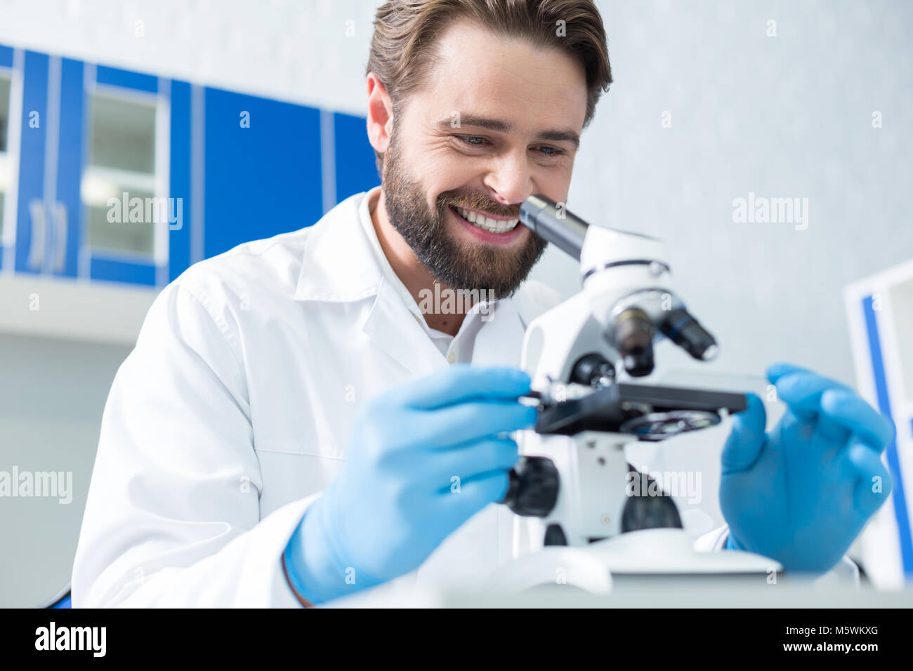 Professional biologist. Happy cheerful positive scientist working with ...