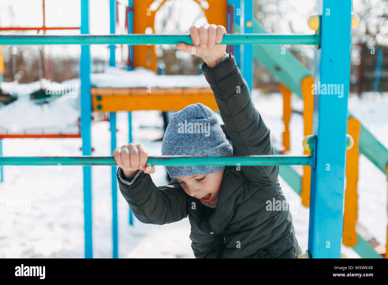 Boy have fun and smile to the camera. Smile and close eyes with snow ...