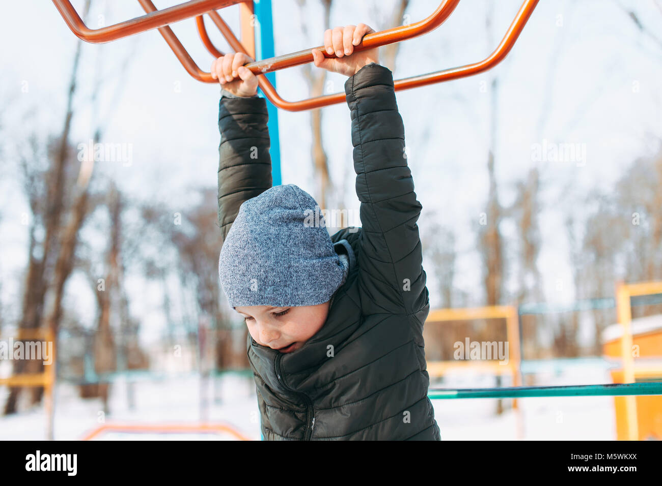 Boy have fun and smile to the camera. Smile and close eyes with snow ...