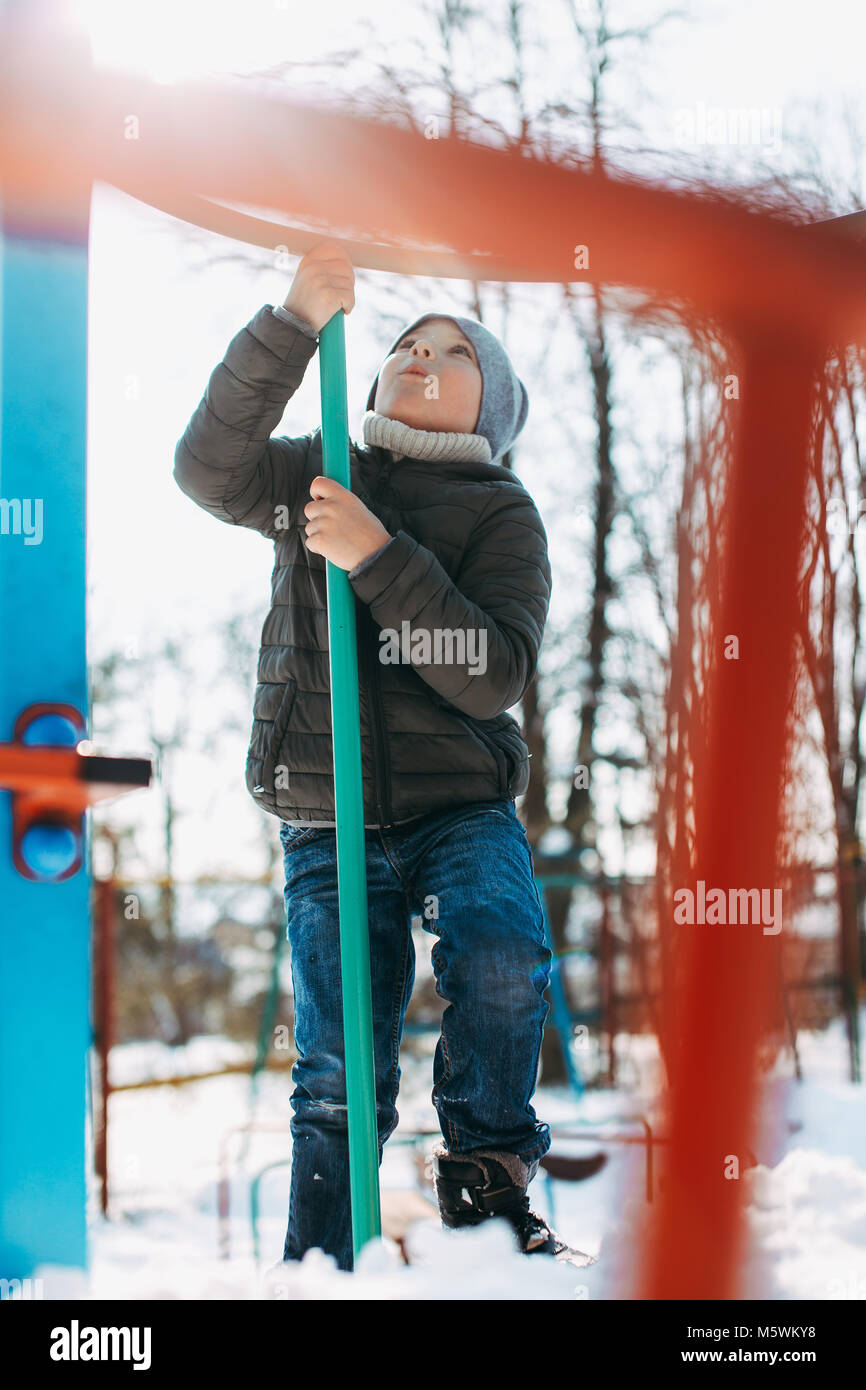 Boy have fun and smile to the camera. Smile and close eyes with snow ...