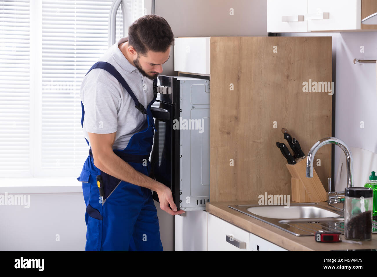 Fixing oven hi-res stock photography and images - Alamy
