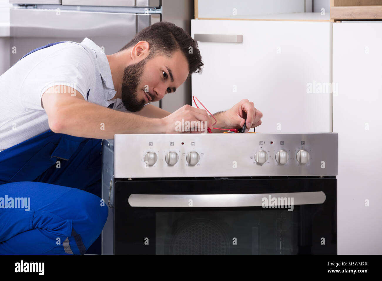 Man crouch kitchen hi-res stock photography and images - Alamy
