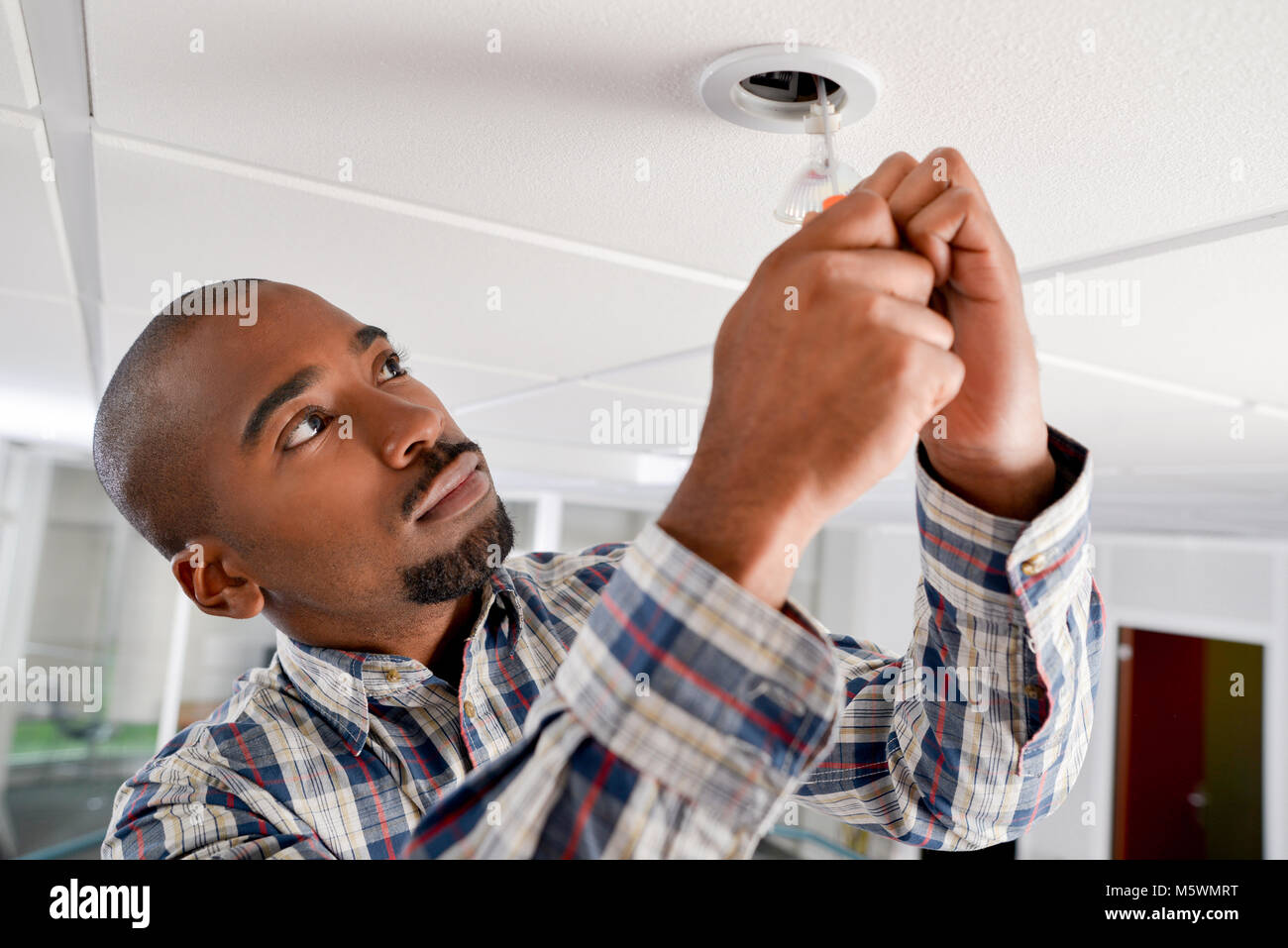 man fixing lighting Stock Photo - Alamy