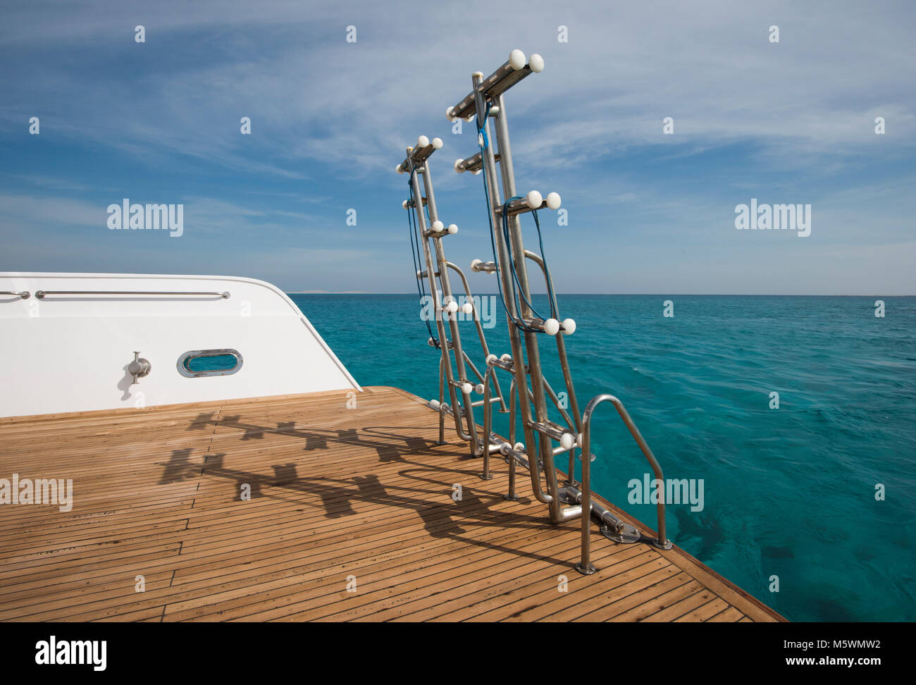 Metal steel ladders on back teak deck of a luxury motor yacht sailing ...