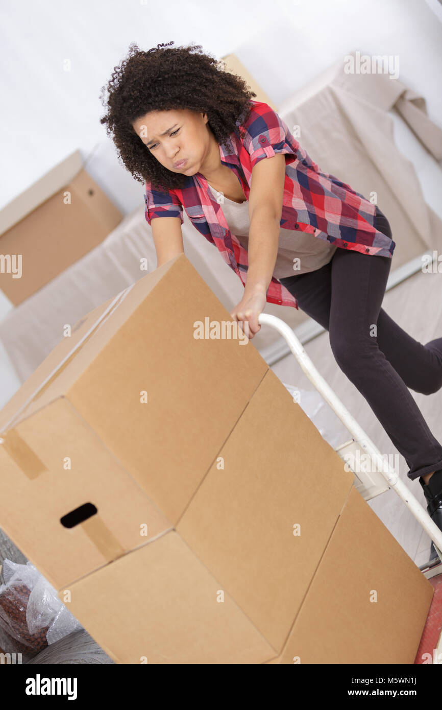 woman moving heavy card boxes Stock Photo - Alamy