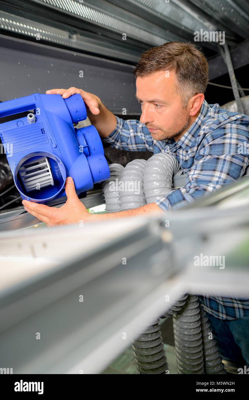 Man installing a new air conditioning unit Stock Photo - Alamy