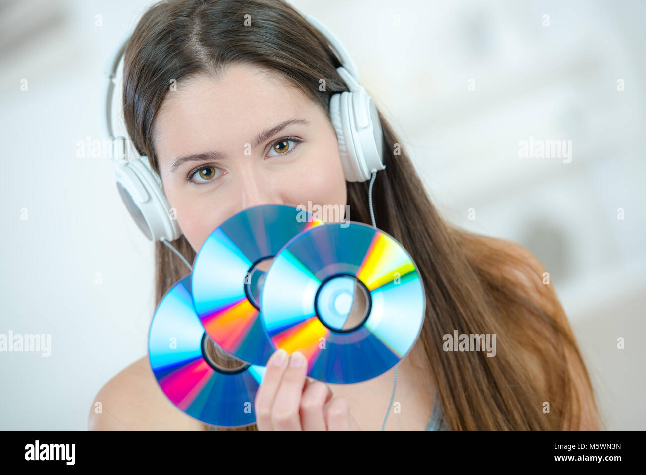woman holding a bunch of cds Stock Photo - Alamy