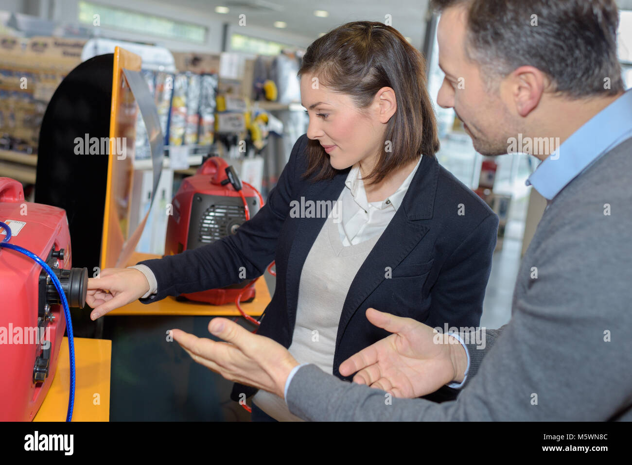 asking the salesman Stock Photo - Alamy
