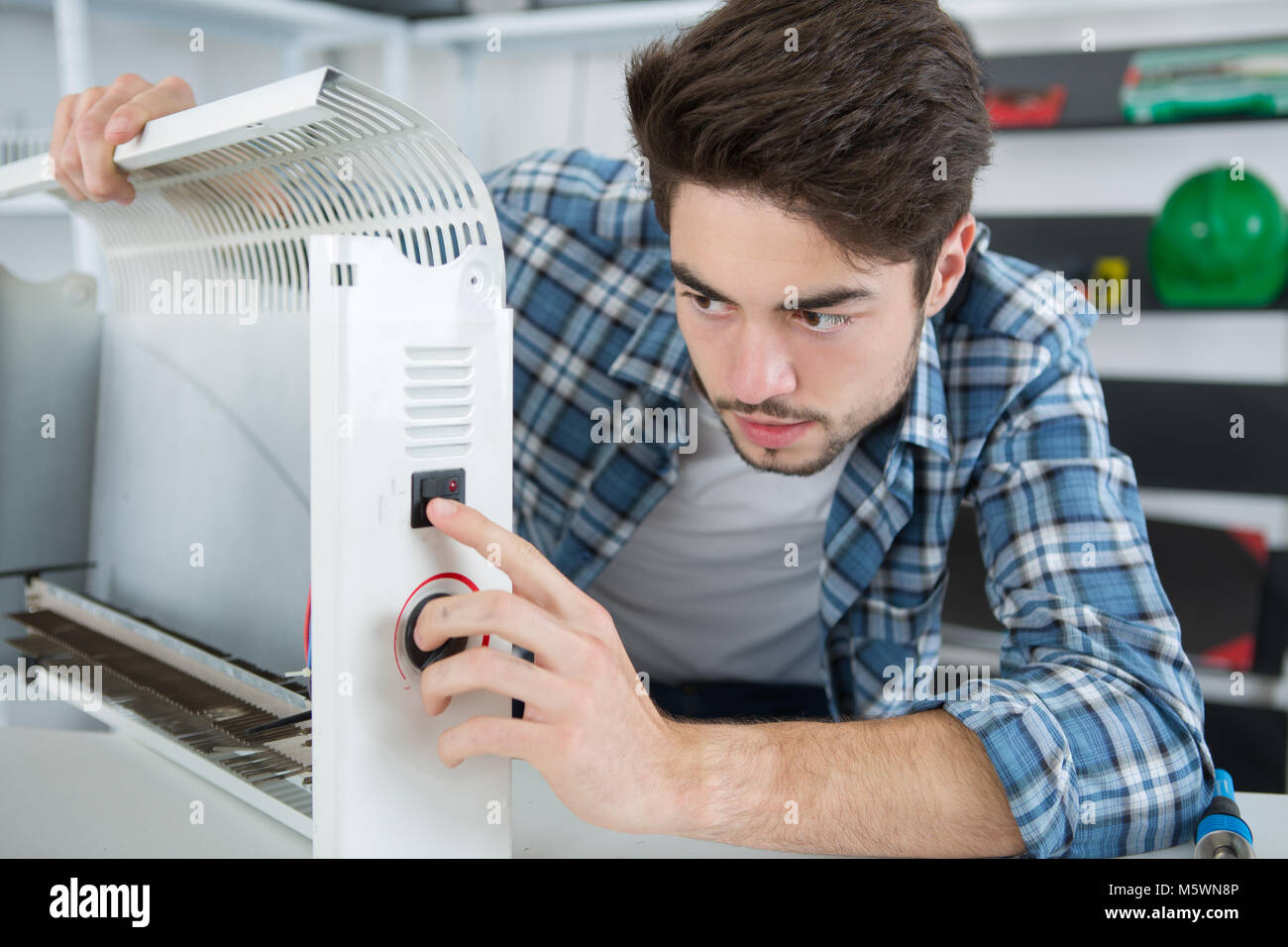Electrician working on appliance Stock Photo - Alamy