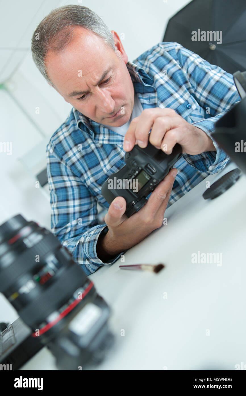 Man working on camera Stock Photo - Alamy