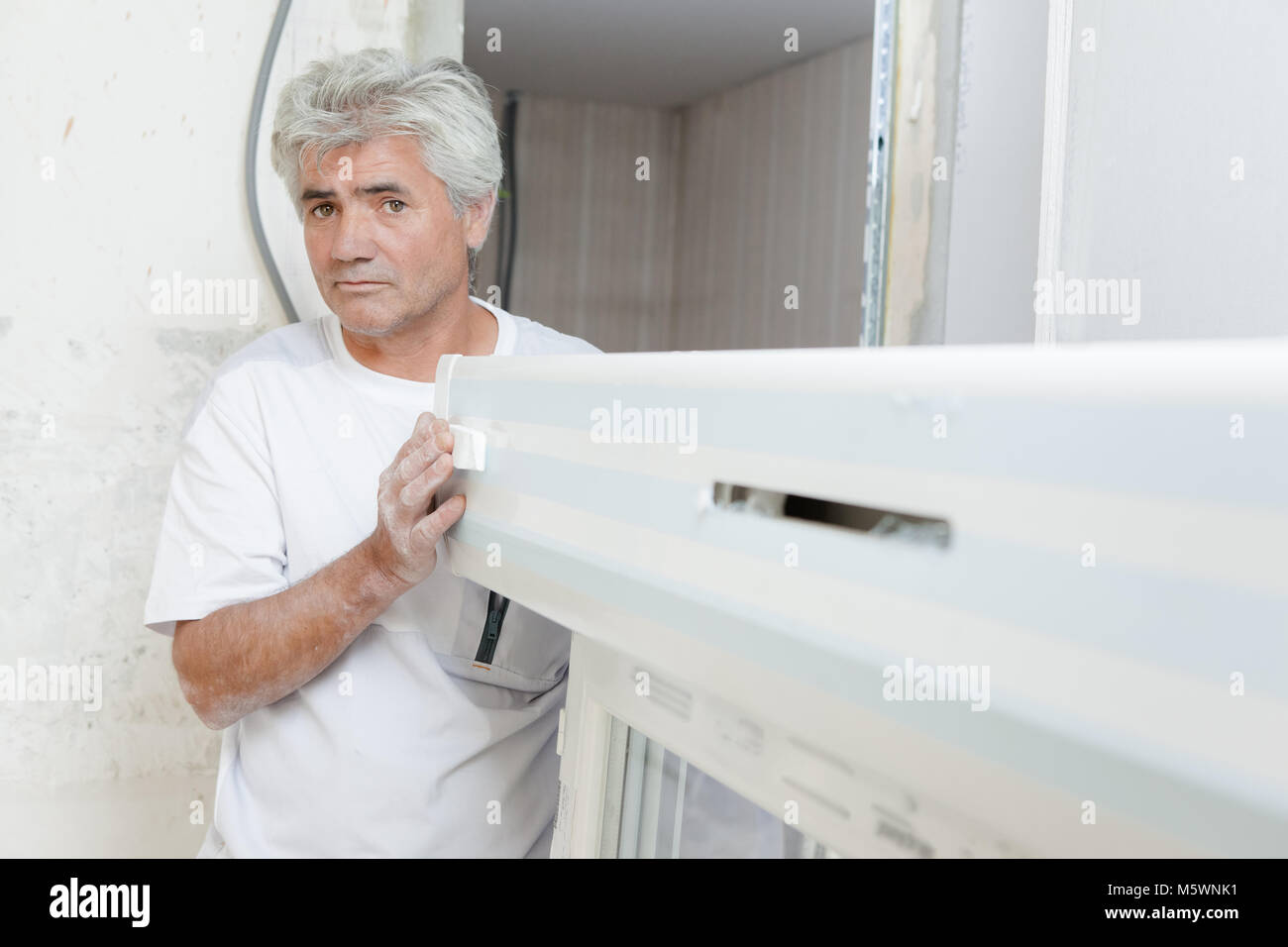 Carrying a new window Stock Photo - Alamy