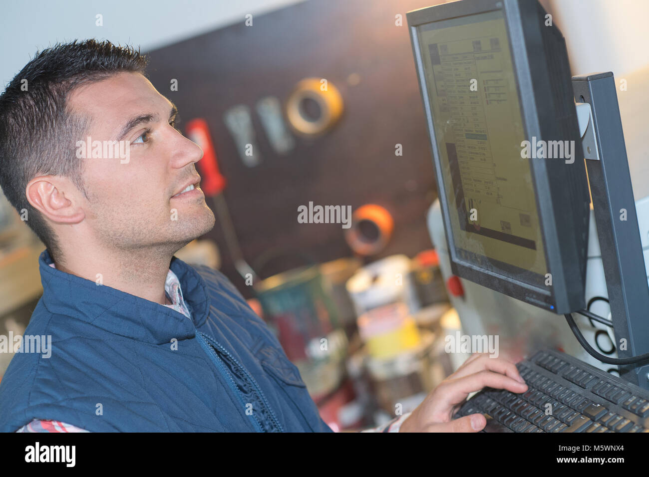 person at computer terminal in distribution warehouse Stock Photo - Alamy