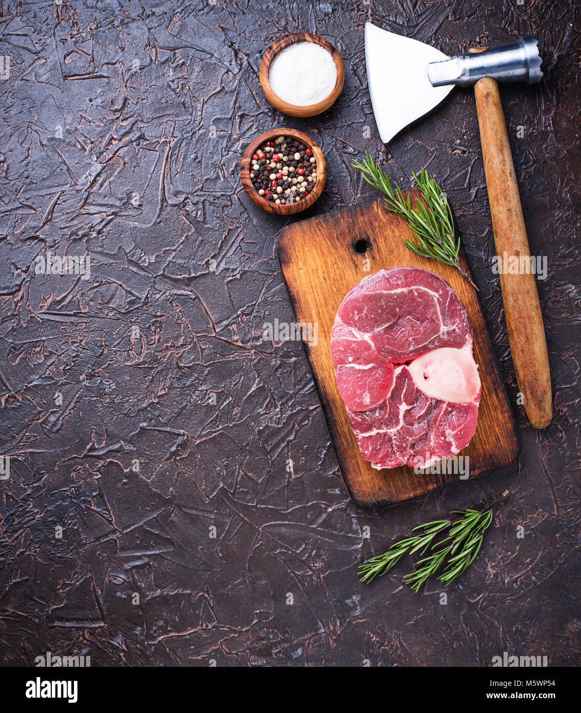 Raw meat osso buco and butchers axe Stock Photo - Alamy