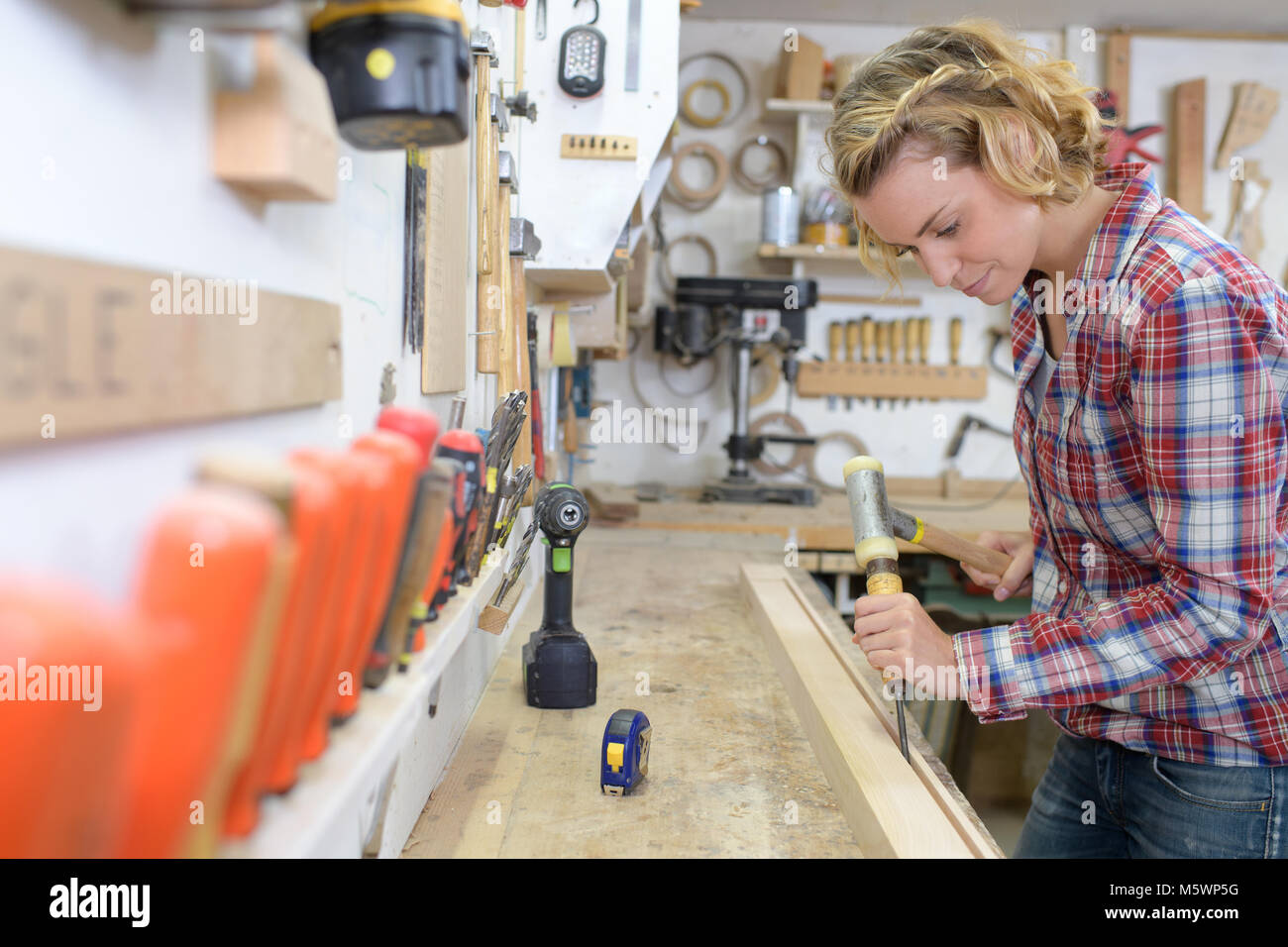 confident female carpenter with a chisel Stock Photo - Alamy