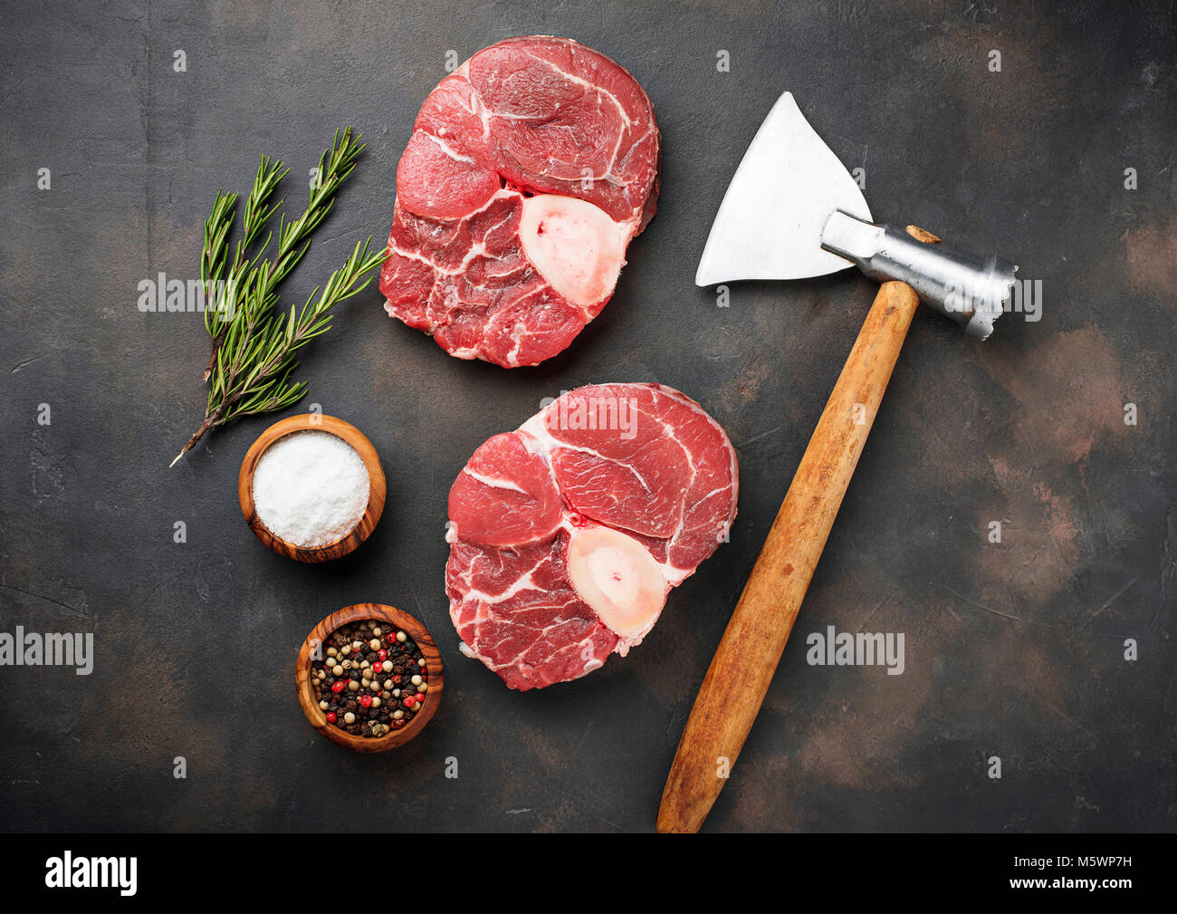 Raw meat osso buco and butchers axe Stock Photo - Alamy