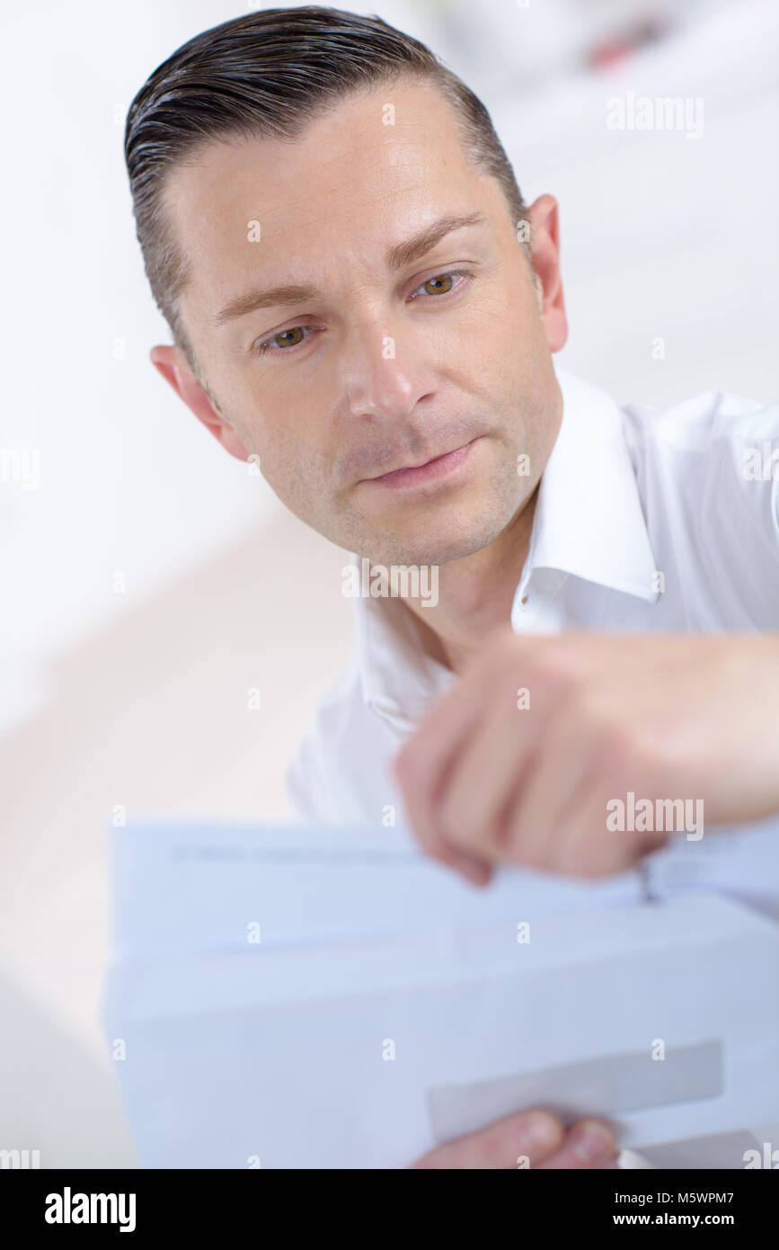 businessman opening a letter Stock Photo - Alamy