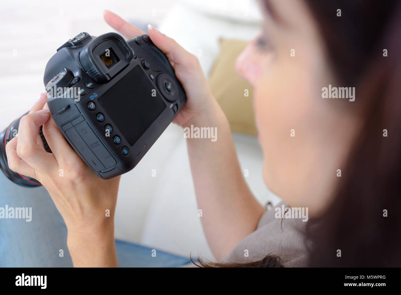 female photographer checking screen of the camera Stock Photo - Alamy