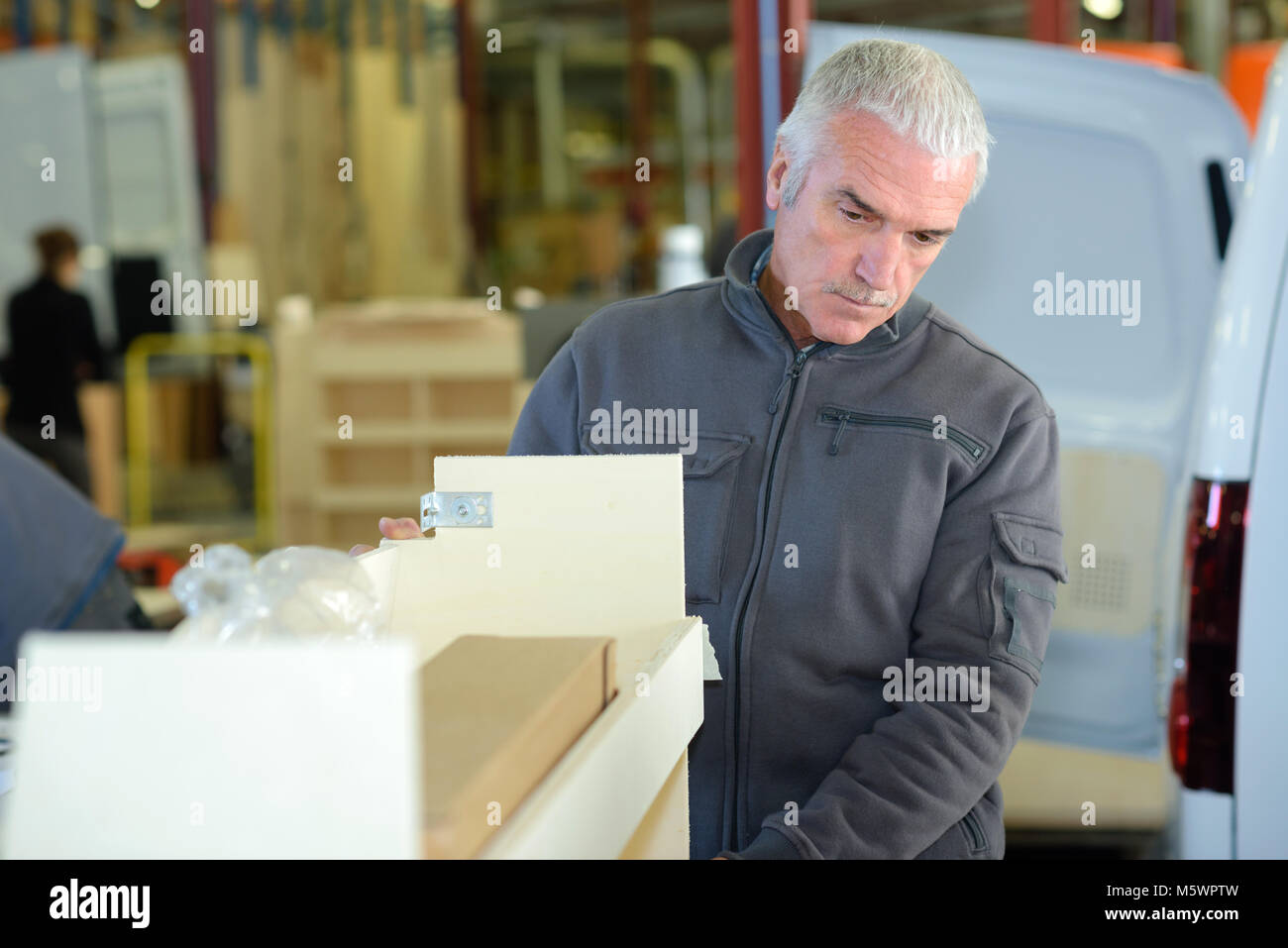 senior delivery man with parcel near truck Stock Photo - Alamy