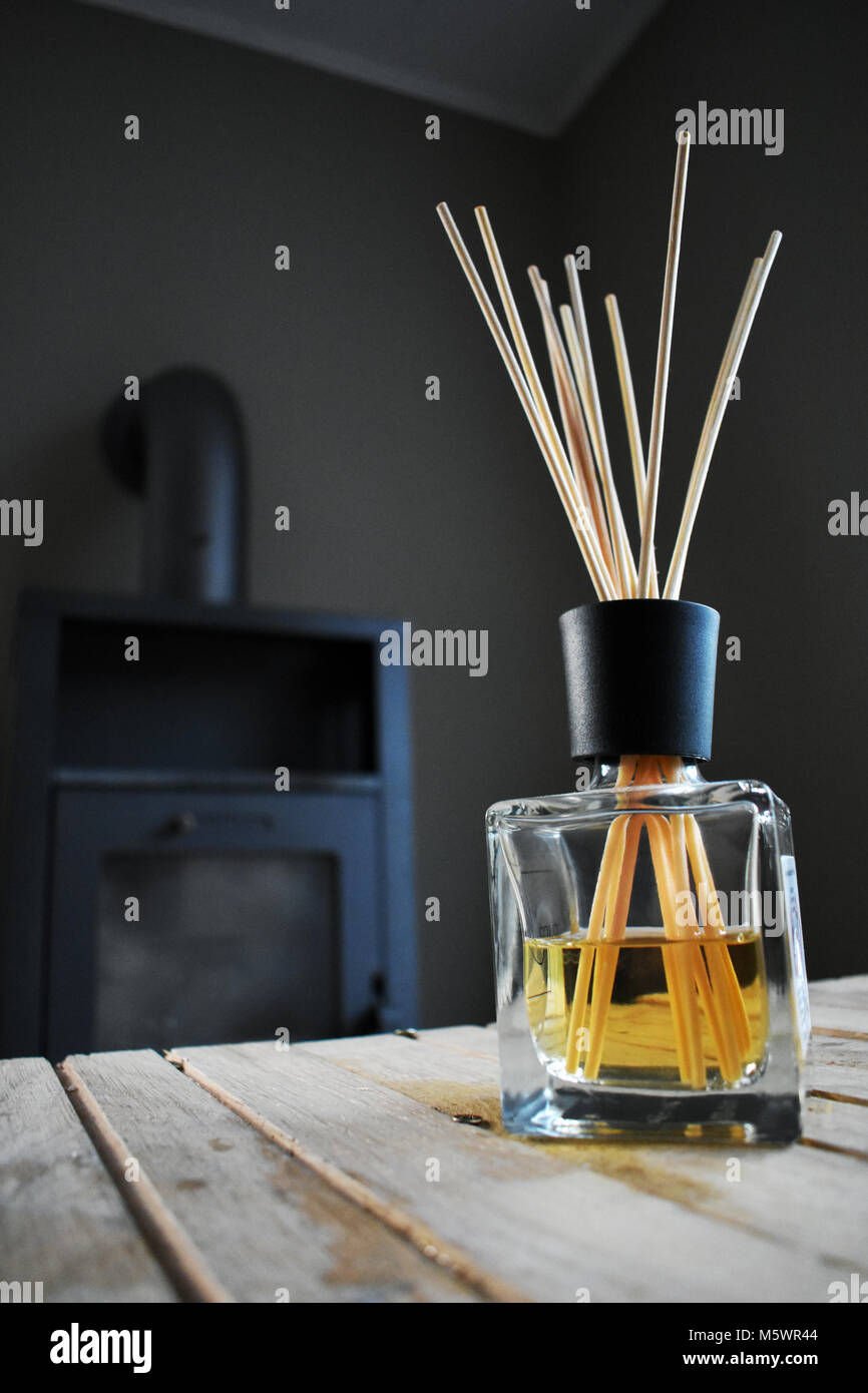 A lovely colored fragrance bottle standing on handmade shaky table by a ...