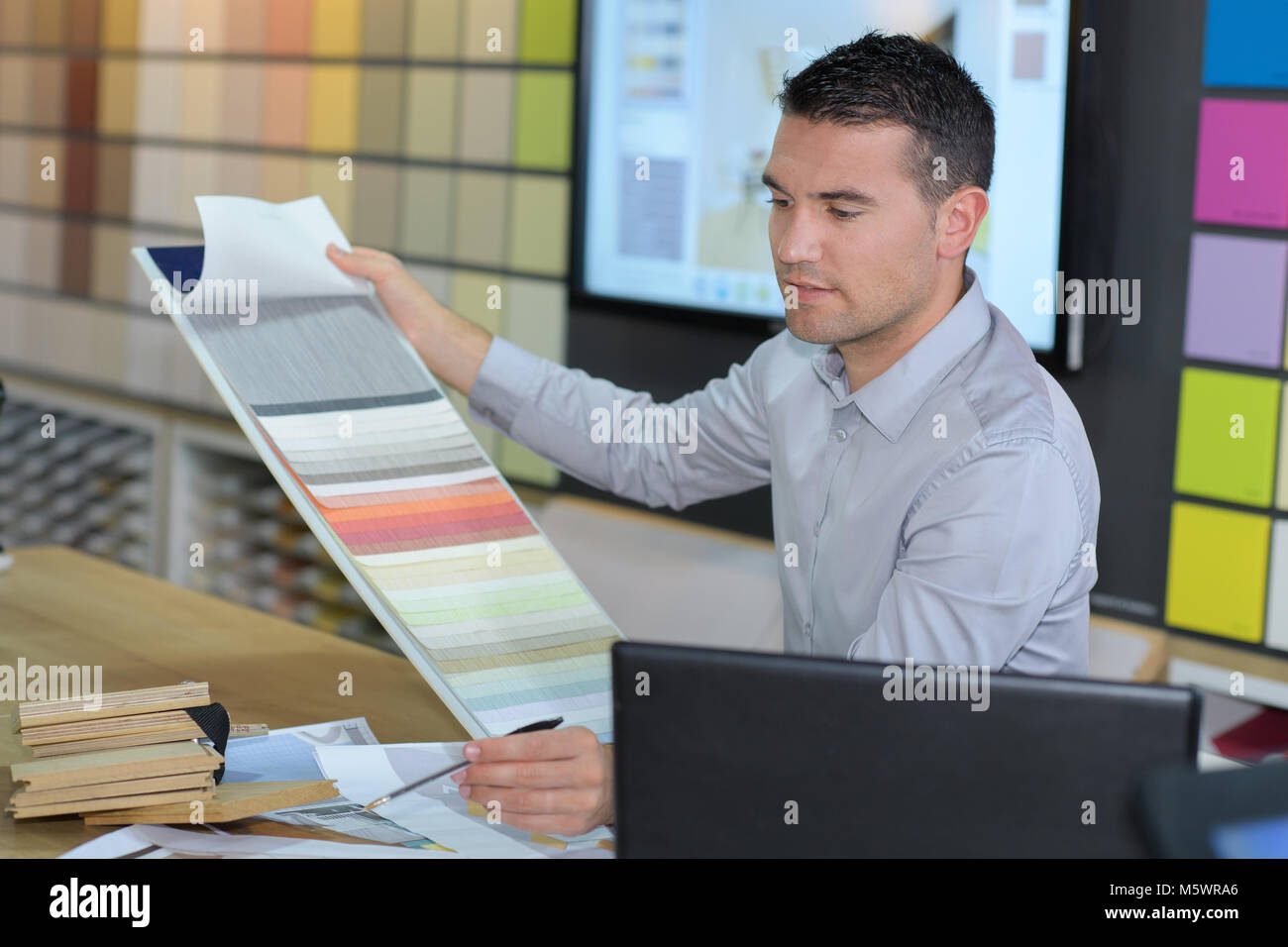 male interior designer at his desk Stock Photo - Alamy