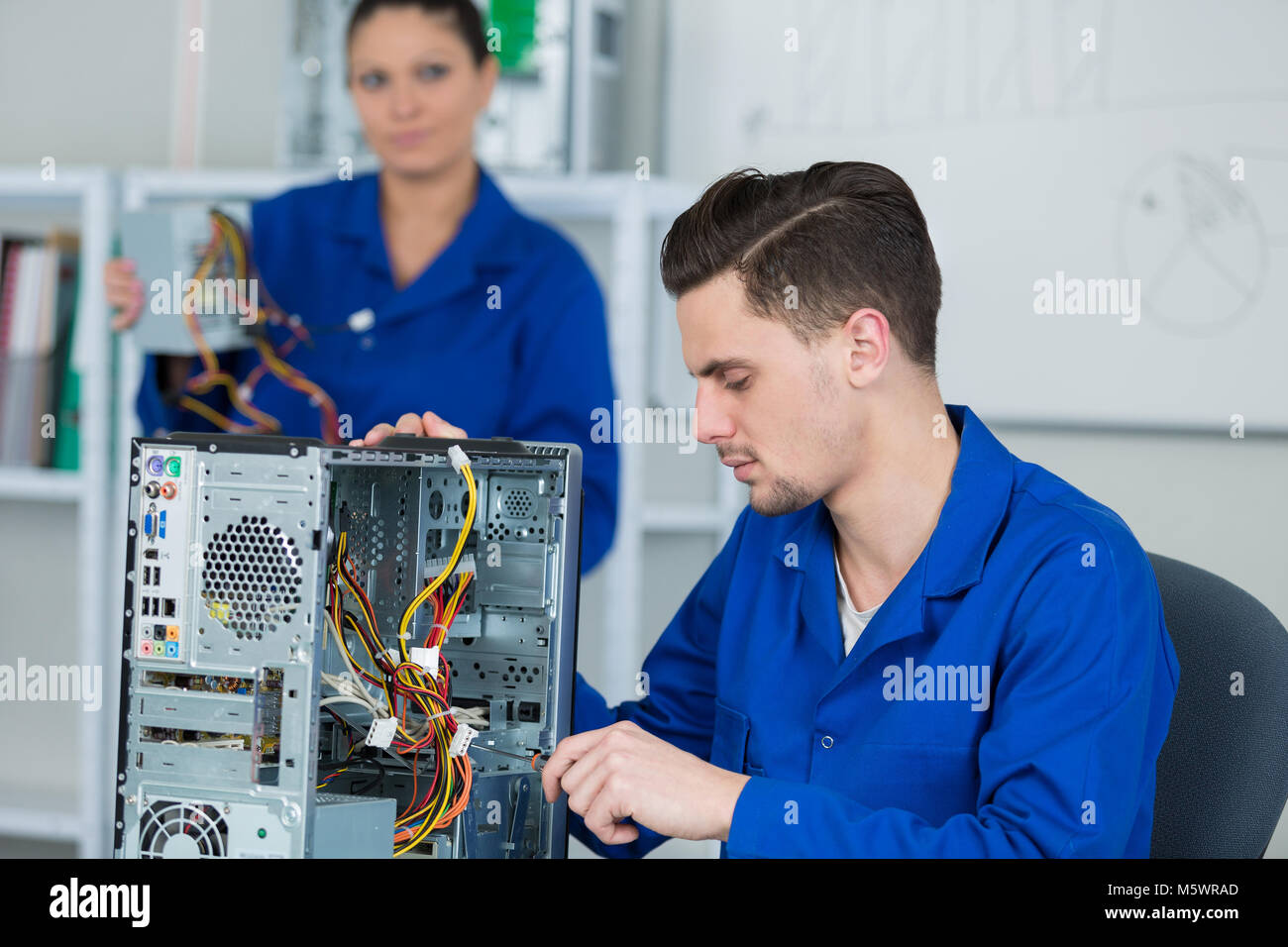team of students examining and repairing computer parts Stock Photo - Alamy