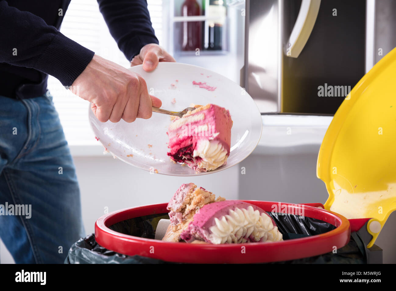 Man throwing food in bin hi-res stock photography and images - Alamy