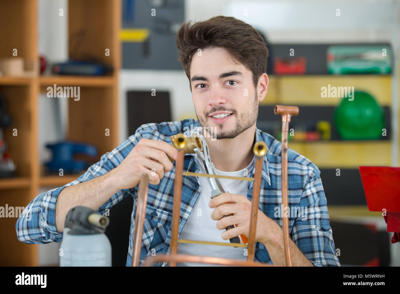 metallurgic worker using copper pipes and fittings Stock Photo - Alamy