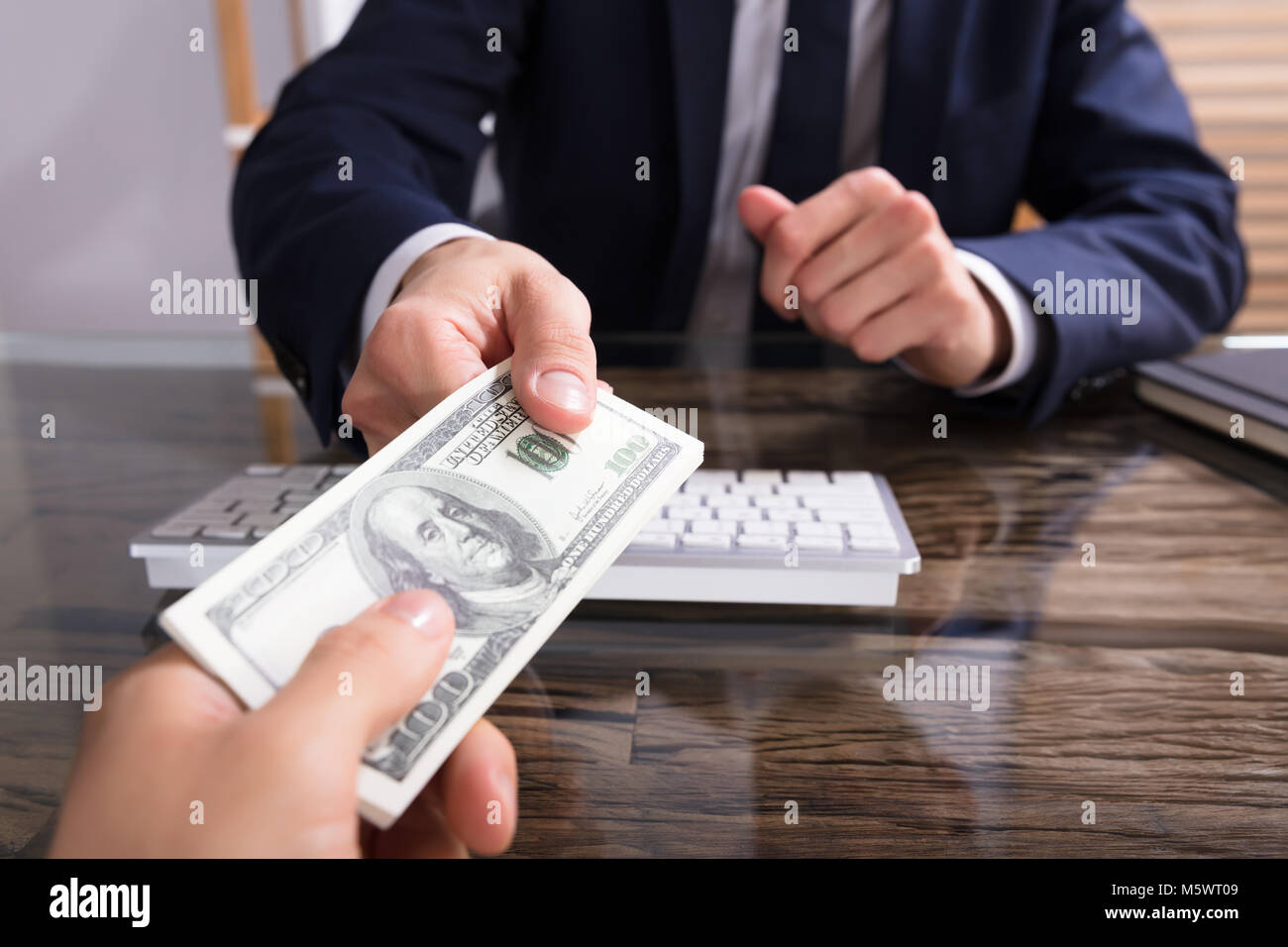 Close-up Of A Person Giving Bribe To Businessperson At Workplace Stock ...