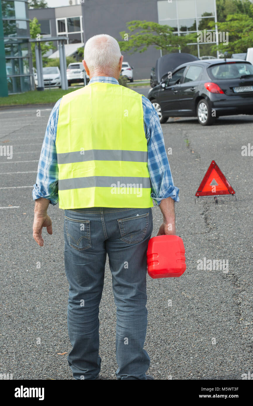 senior aged man holding gas can to refill his car Stock Photo - Alamy