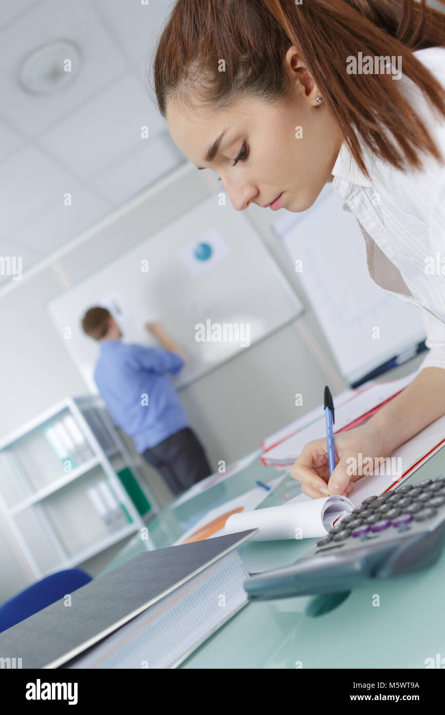 accounting student writing notes Stock Photo - Alamy