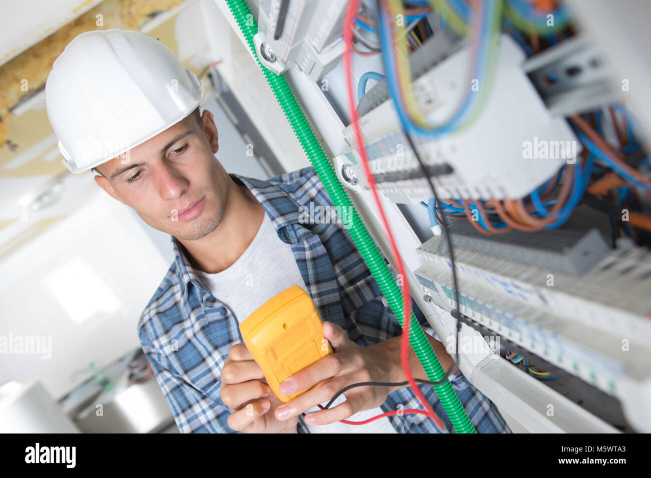 young electrician using a multimeter Stock Photo - Alamy
