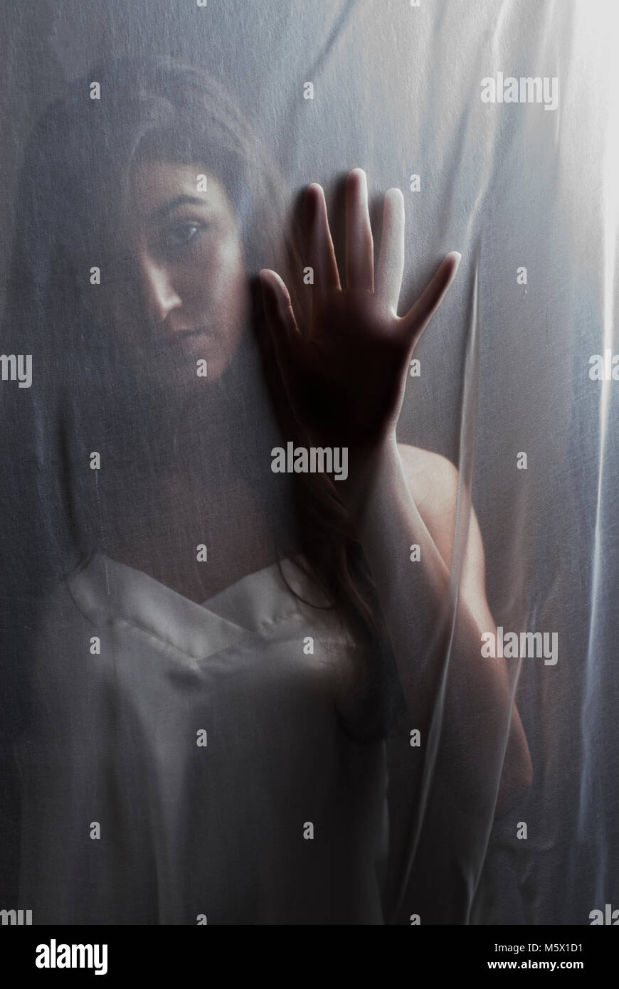 Serious young woman hand touching the blinds Stock Photo - Alamy
