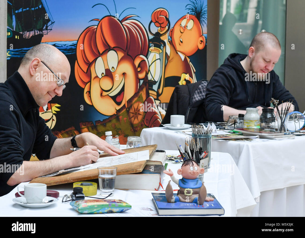 26 February 2018, Germany, Berlin: Illustrators Thomas Schiewer (L) and ...