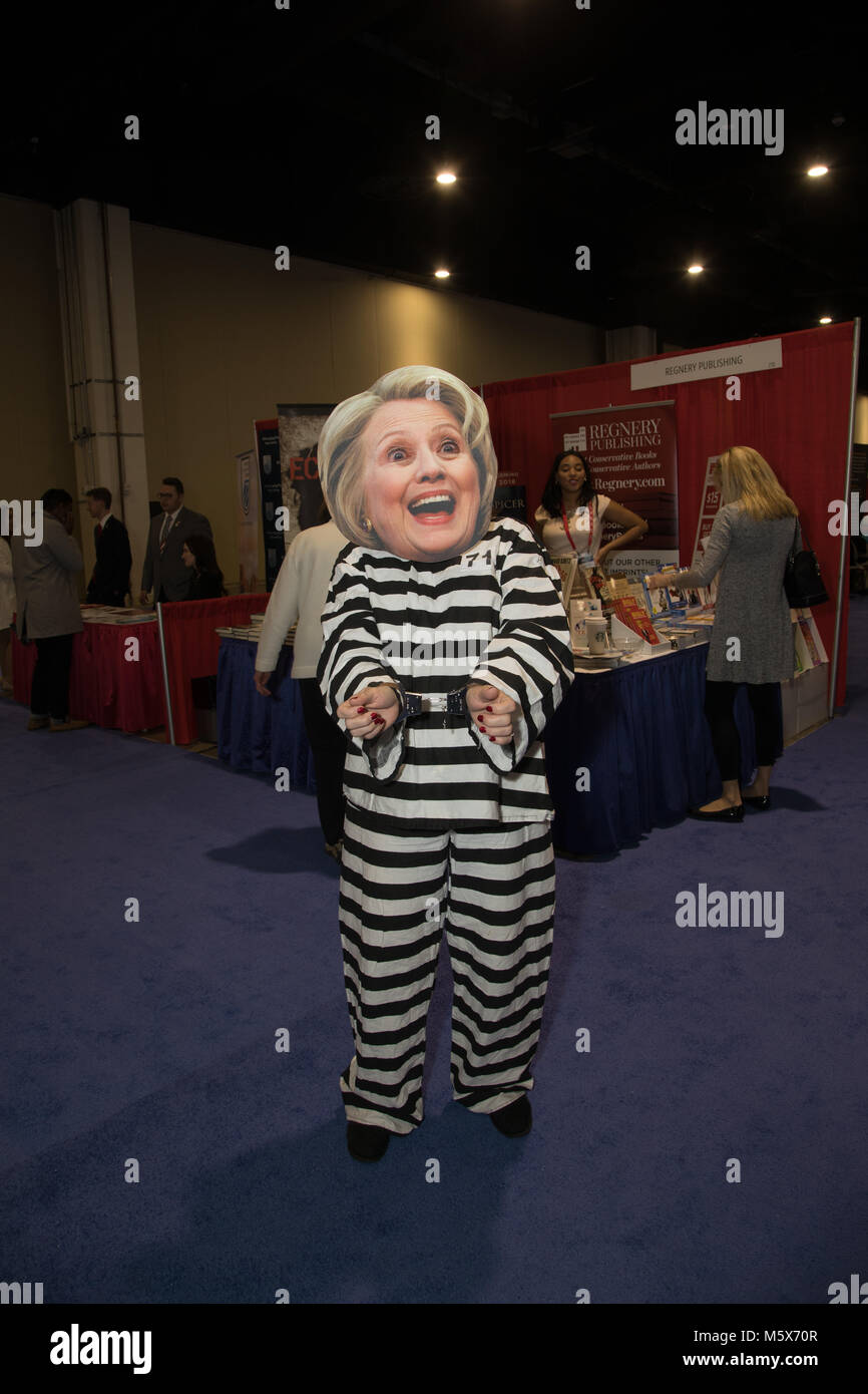 A women dressed as Hillary Clinton in a striped prison uniform wearing ...