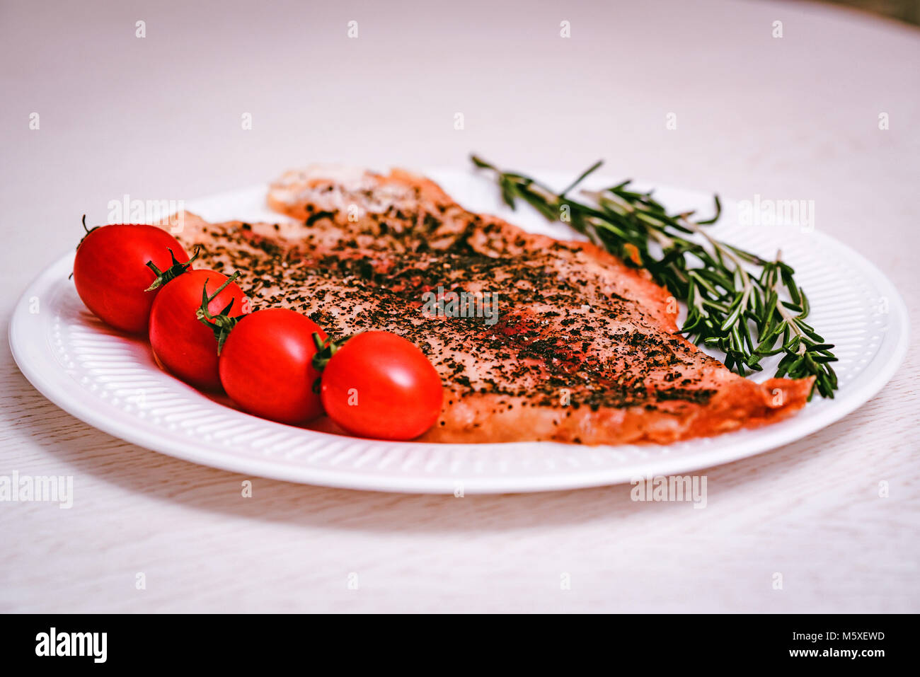 Roasted fish fillet with vegetables close Stock Photo - Alamy