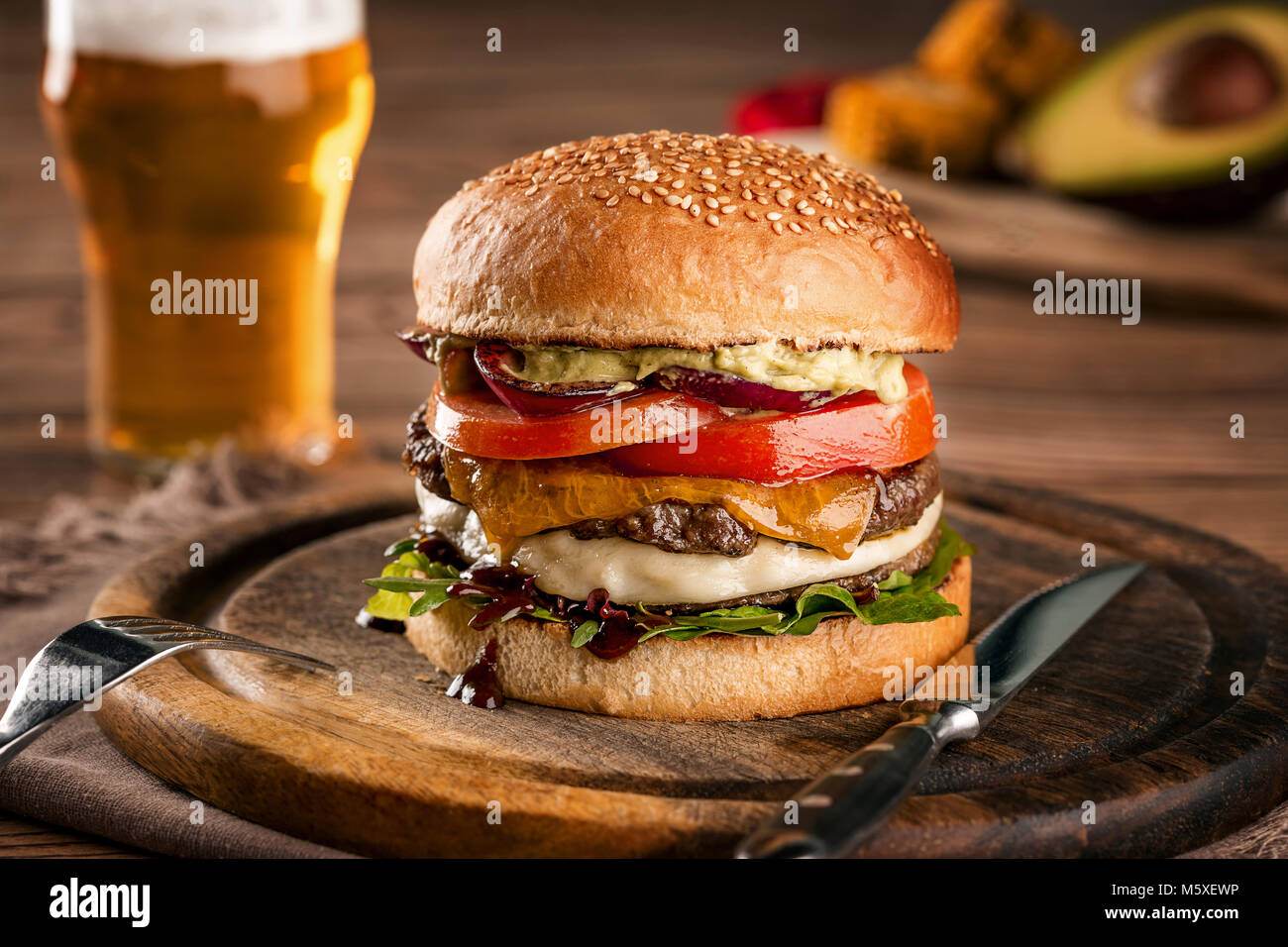 Appetizing cheeseburger, made from sesame seeds sprinkled rye bun with ...