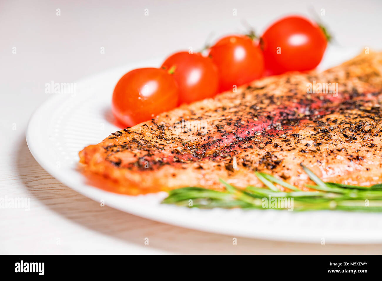 Roasted fish fillet with vegetables close Stock Photo - Alamy