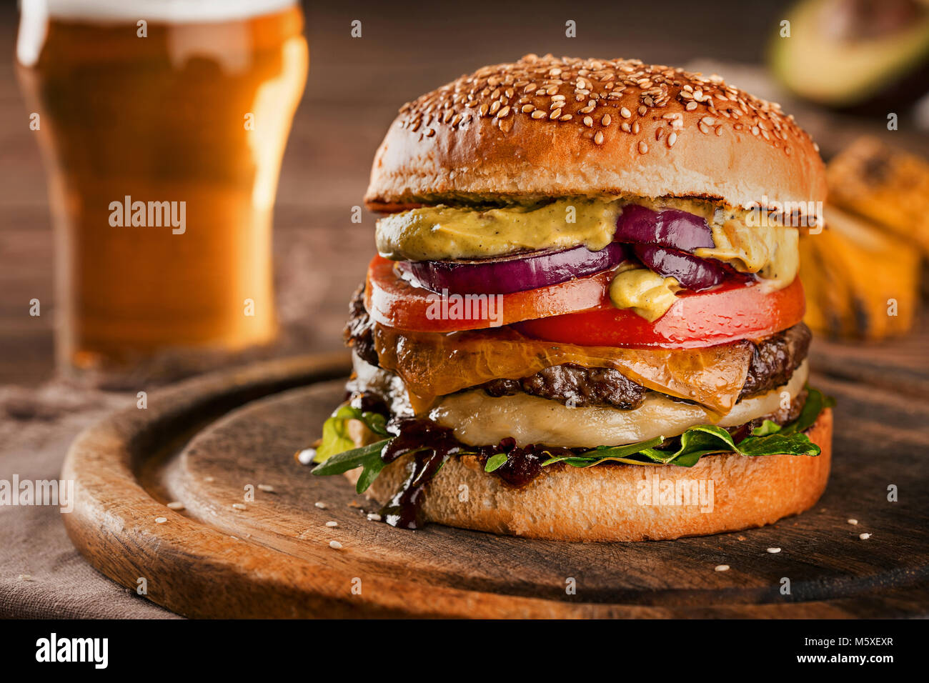 Appetizing cheeseburger, made from sesame seeds sprinkled rye bun with ...