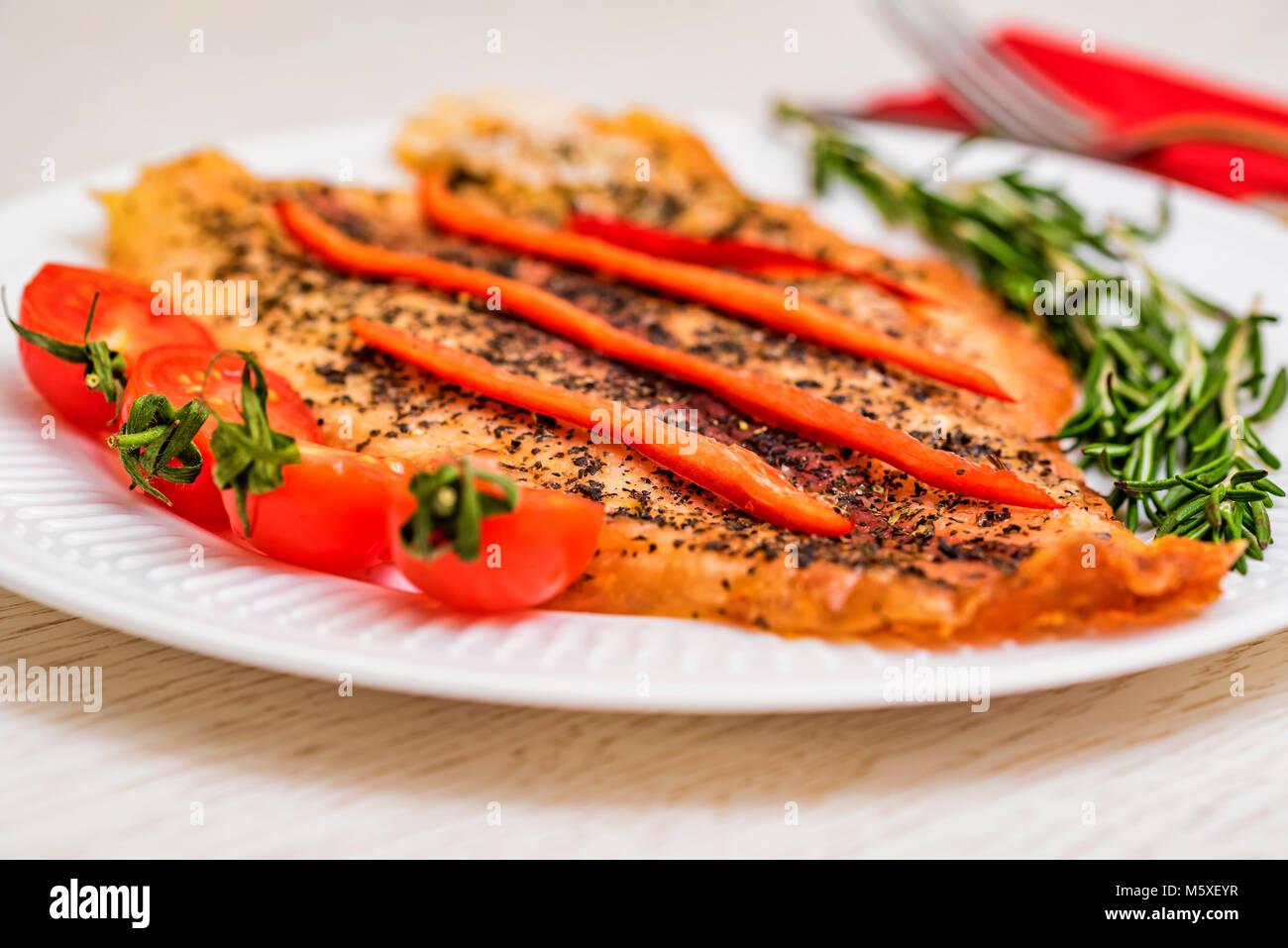 Roasted fish fillet with vegetables close Stock Photo - Alamy
