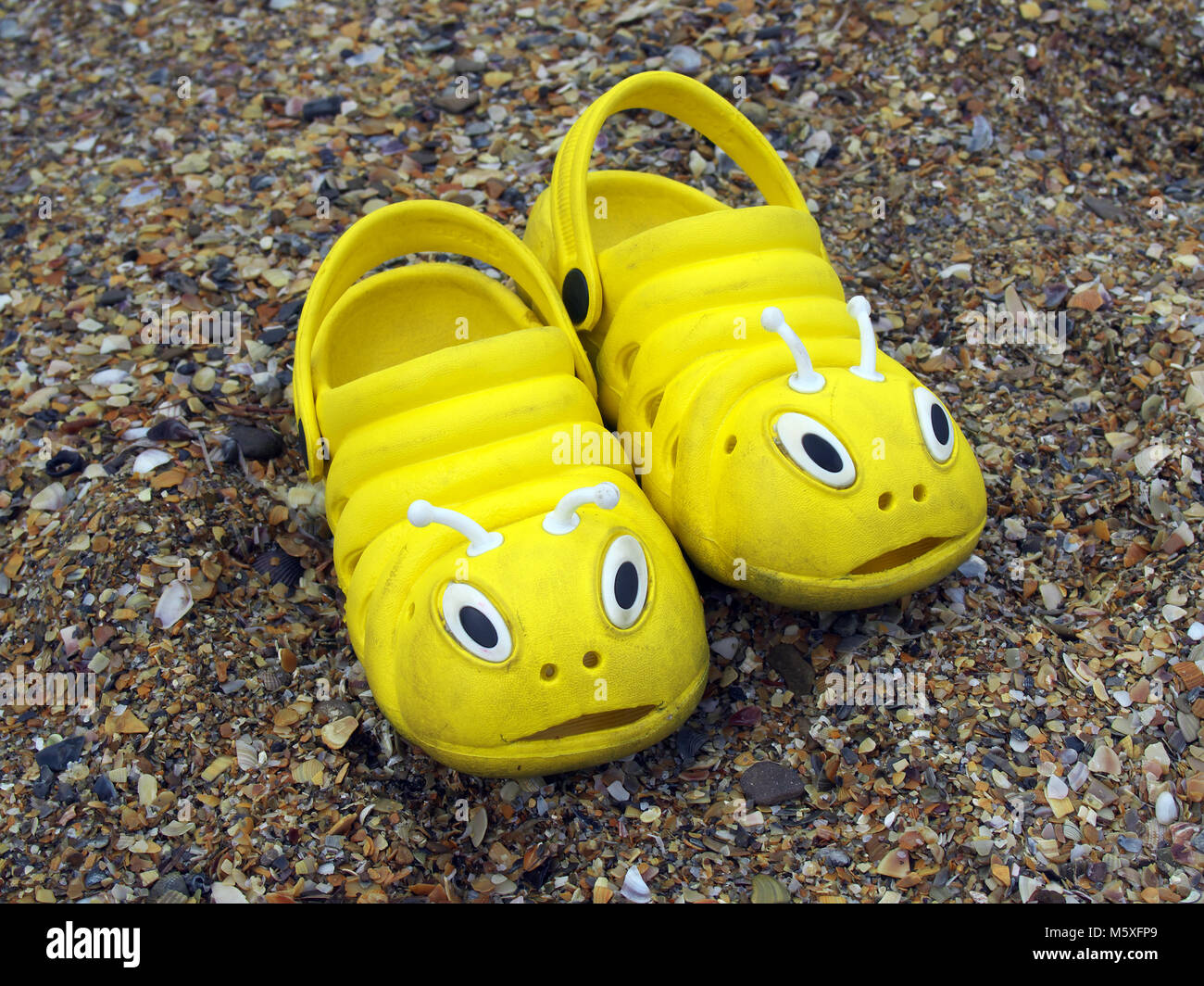 Yellow beach slippers in the form of caterpillars Stock Photo - Alamy